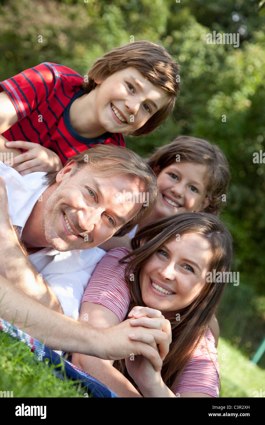 Germany, Bavaria, Family lying on grass, smiling, portrait Stock Photo ...
