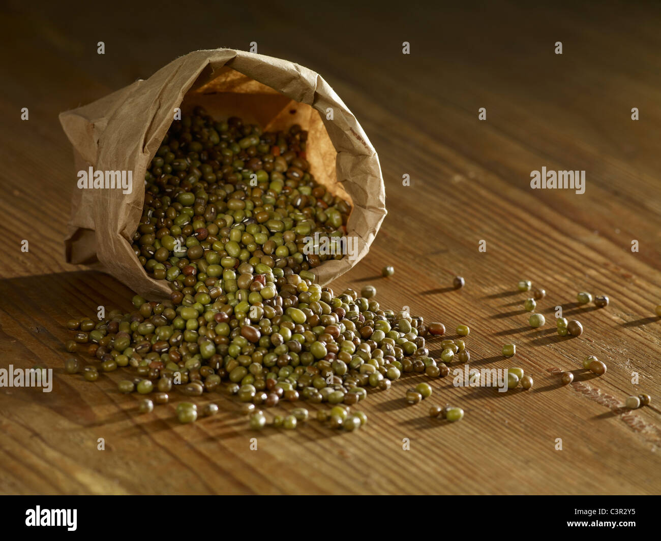 Brown mung beans spilled on wooden surface Stock Photo - Alamy