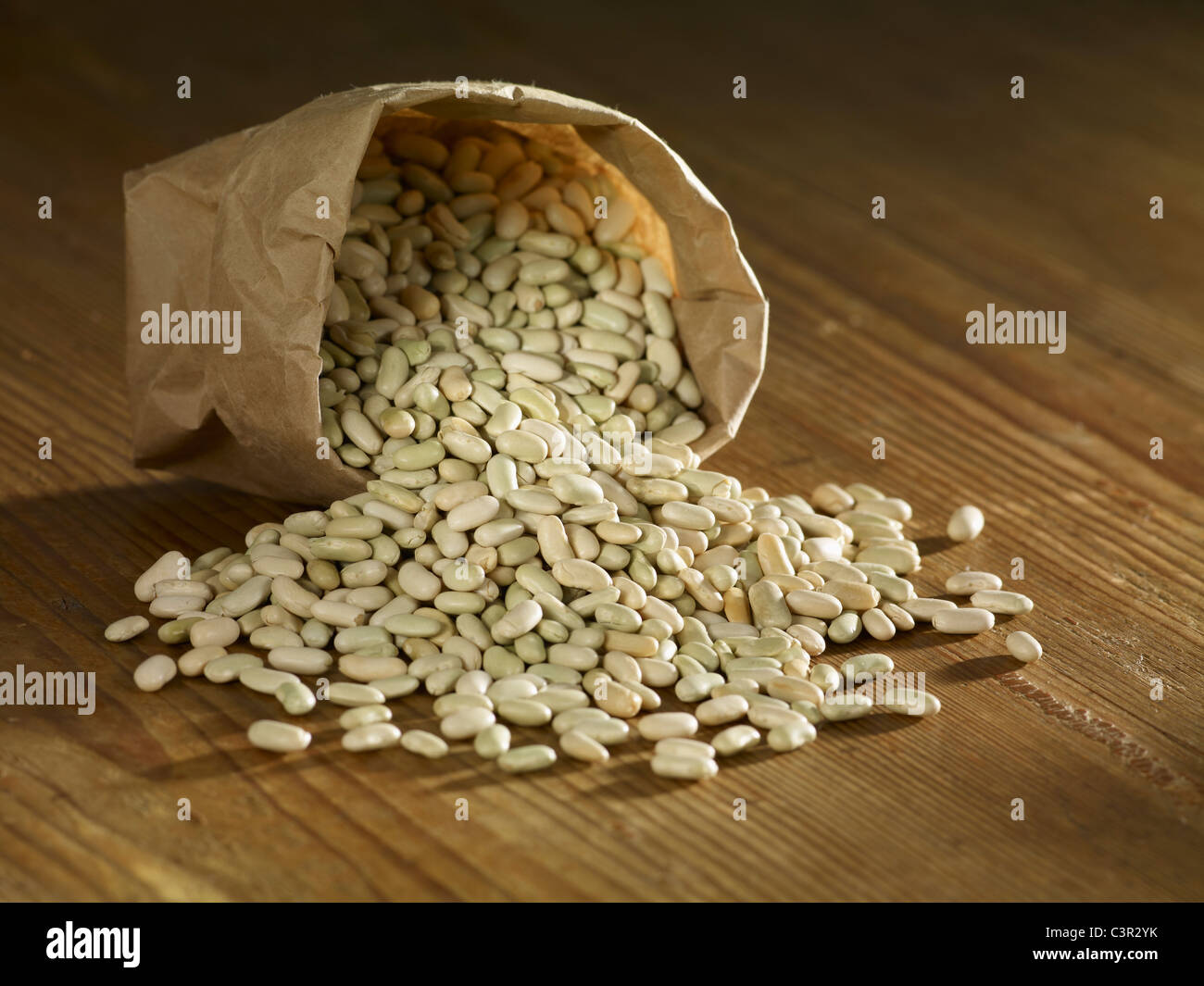 Flageolet beans spilled on wooden surface Stock Photo - Alamy