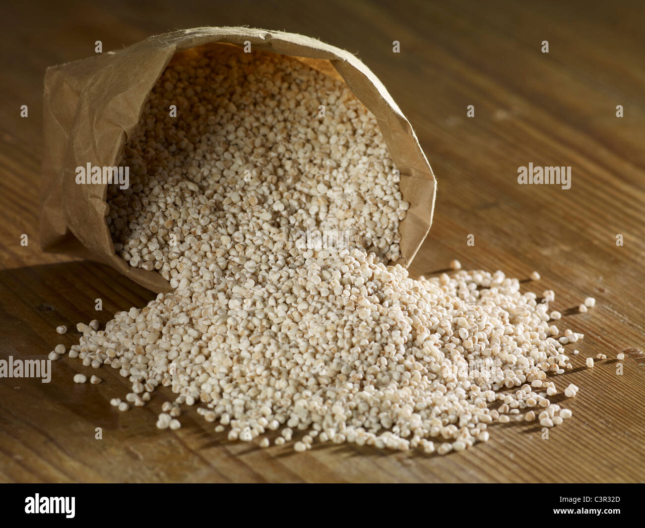 Pearl barley spilling on wooden surface Stock Photo - Alamy