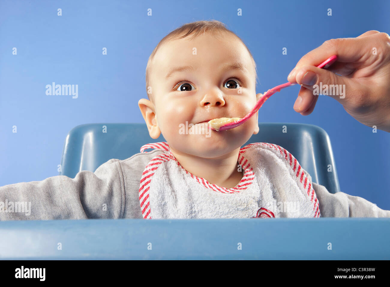 Human hand feeding baby boy Stock Photo - Alamy