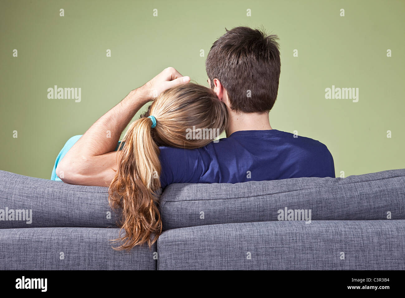Young couple resting on couch, rear view Stock Photo - Alamy
