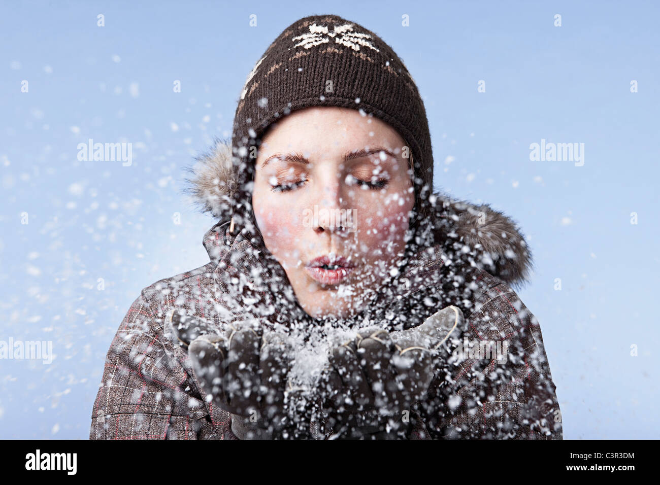 Young woman blowing snow, close-up Stock Photo - Alamy
