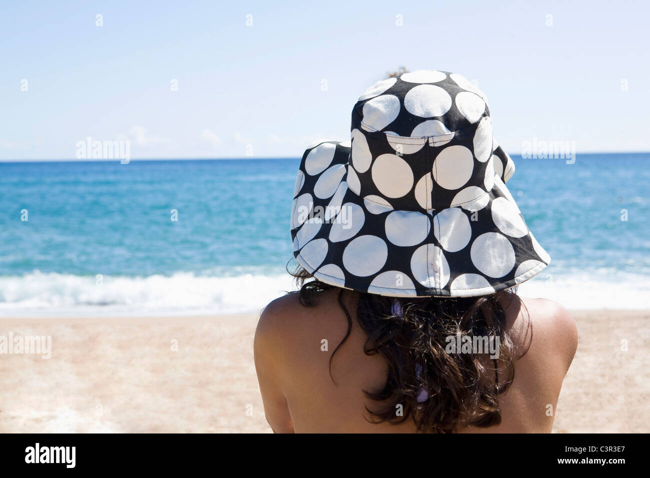 France, Corsica, Woman relaxing on beach, rear view Stock Photo - Alamy