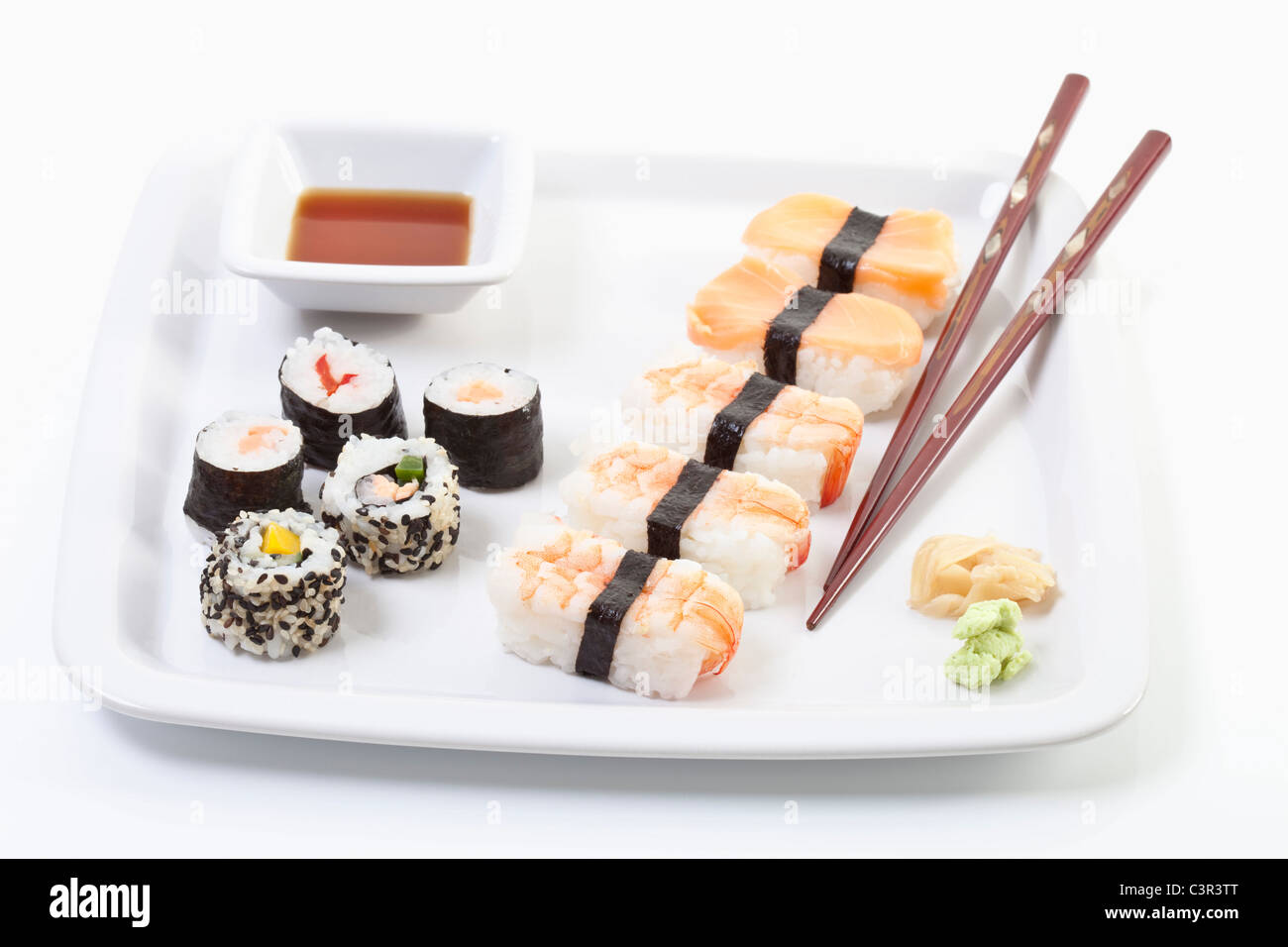 Maki sushi in square plate on white background Stock Photo - Alamy