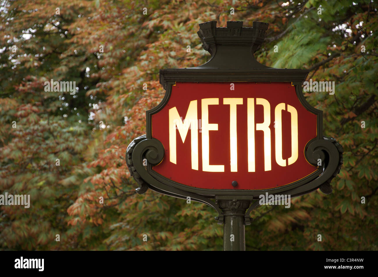 An iconic Parisian Art Nouveau Métro sign, against a background of ...