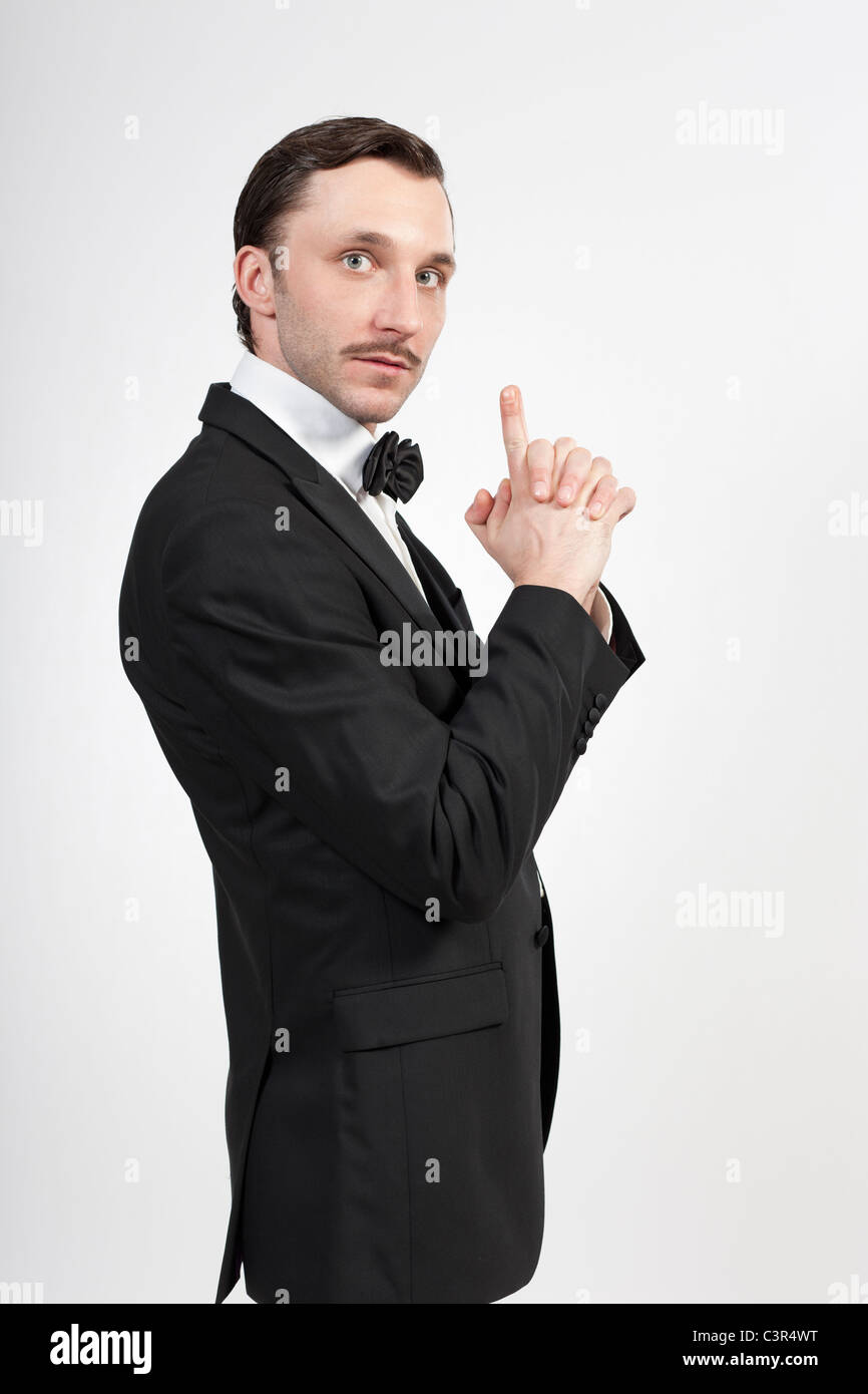 Man showing gun sign, portrait Stock Photo - Alamy