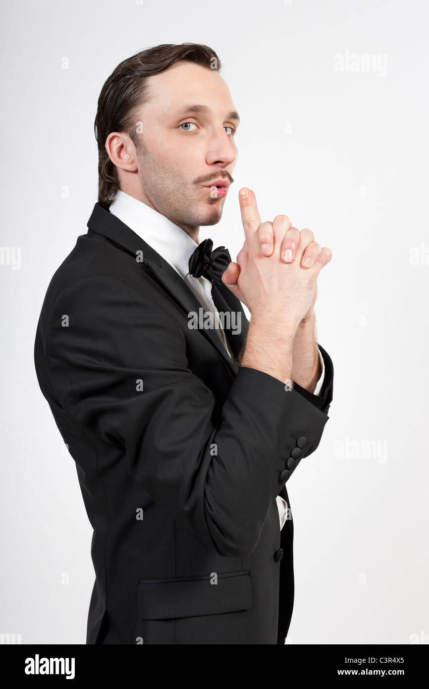 Man showing gun sign, portrait Stock Photo - Alamy