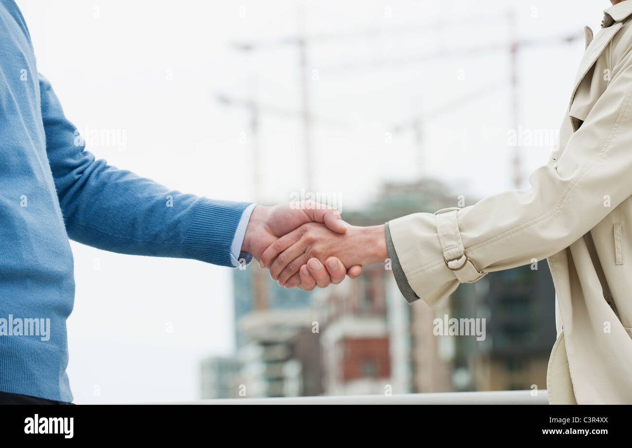 Germany, Hamburg, Man and woman shaking hands, close up Stock Photo - Alamy