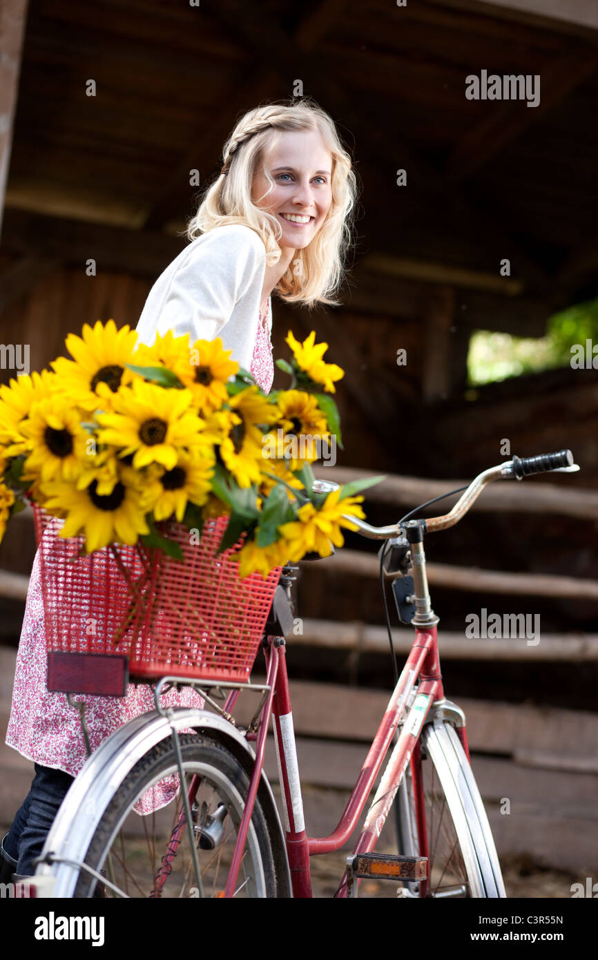 Germany, Saxony, Young woman looking away and smiling Stock Photo - Alamy