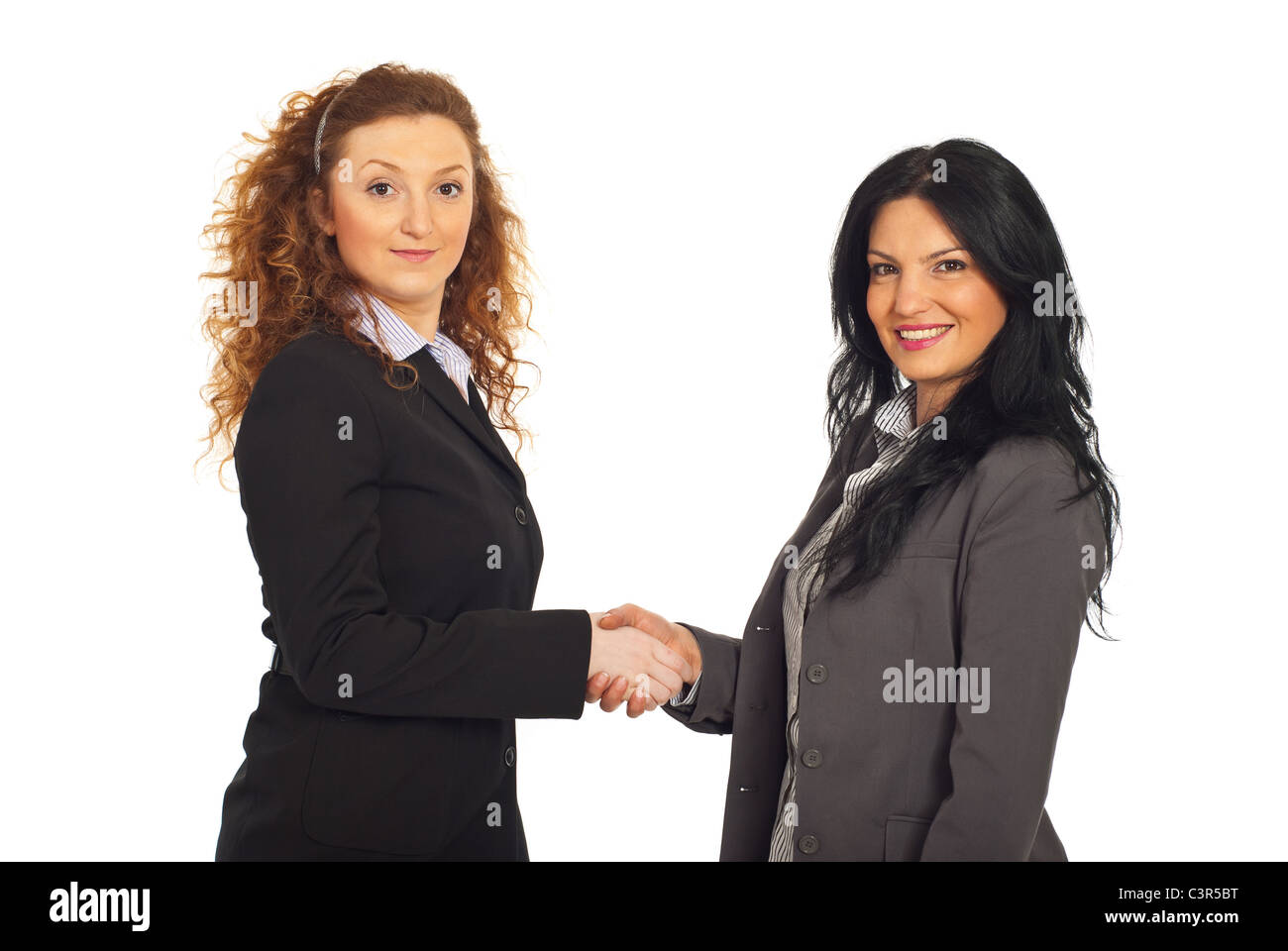 Two happy business women giving handshake isolated on white background ...
