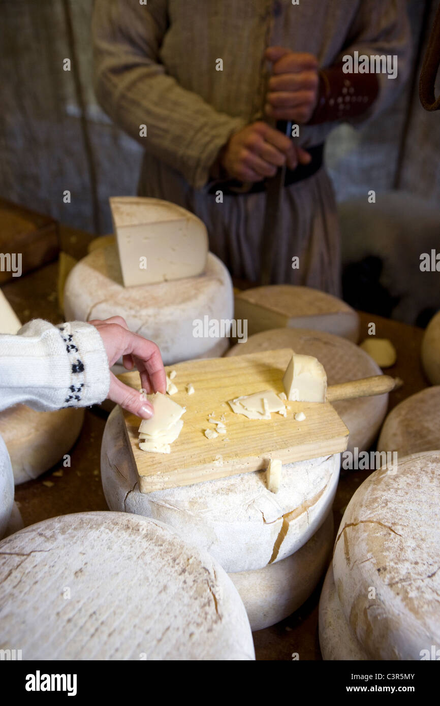 A lady's hand taking a piece of cheese Stock Photo - Alamy