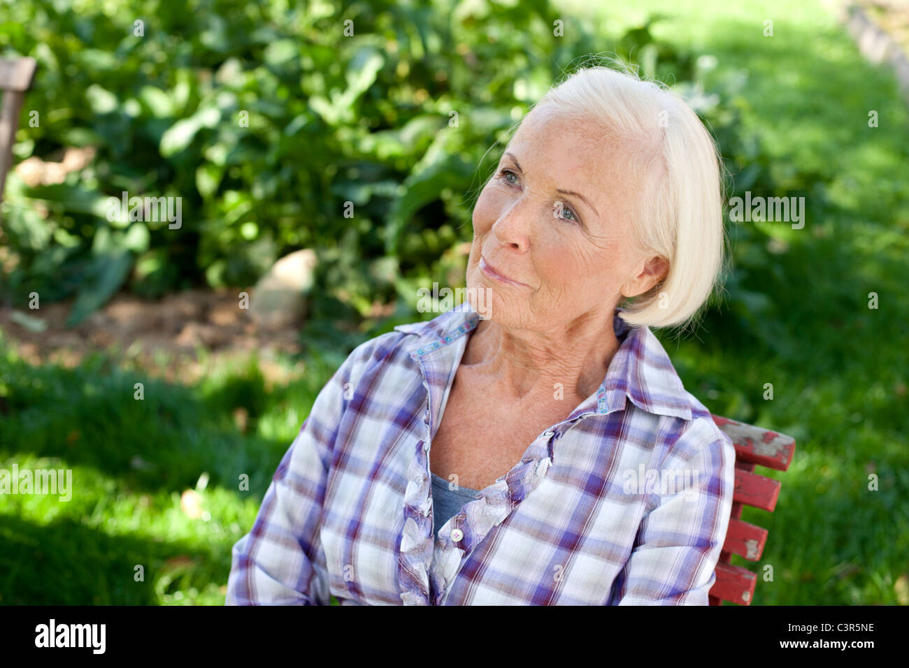 Germany, Saxony, Senior woman relaxing at the farm Stock Photo - Alamy