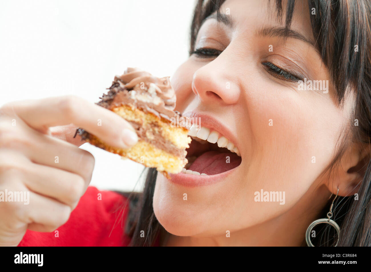 Smiling woman eating chocolate cake Stock Photo - Alamy