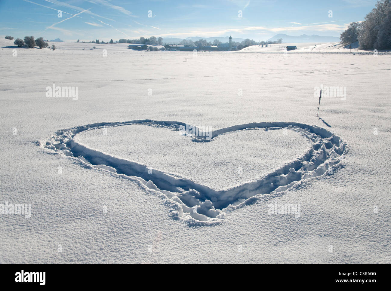 Heart shape in pristine snow Stock Photo - Alamy