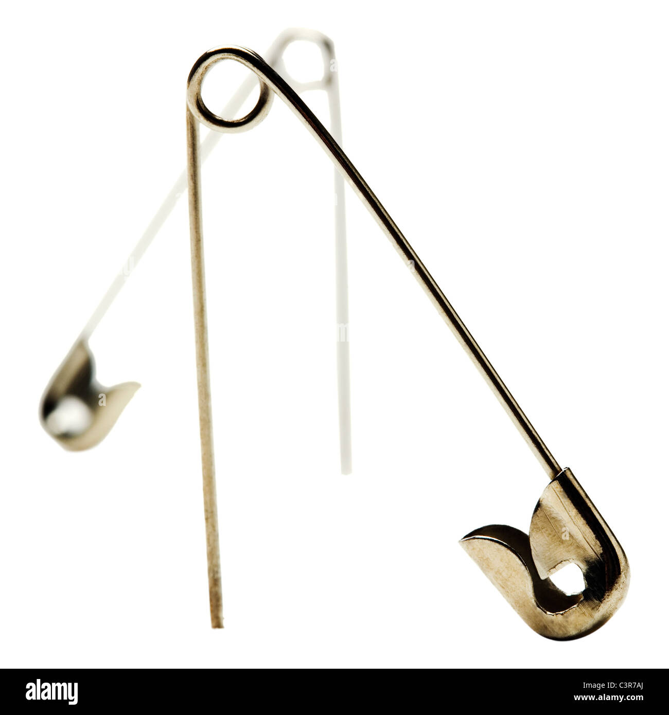 Two safety pins isolated over white Stock Photo - Alamy