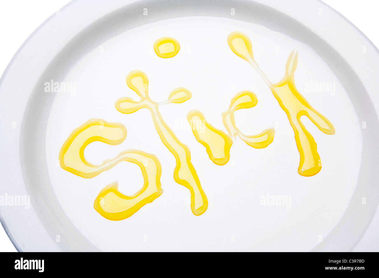 Stick text written with honey on a plate isolated over white Stock ...