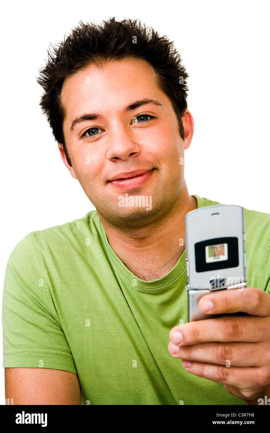 Smiling man text messaging on a mobile phone isolated over white Stock ...
