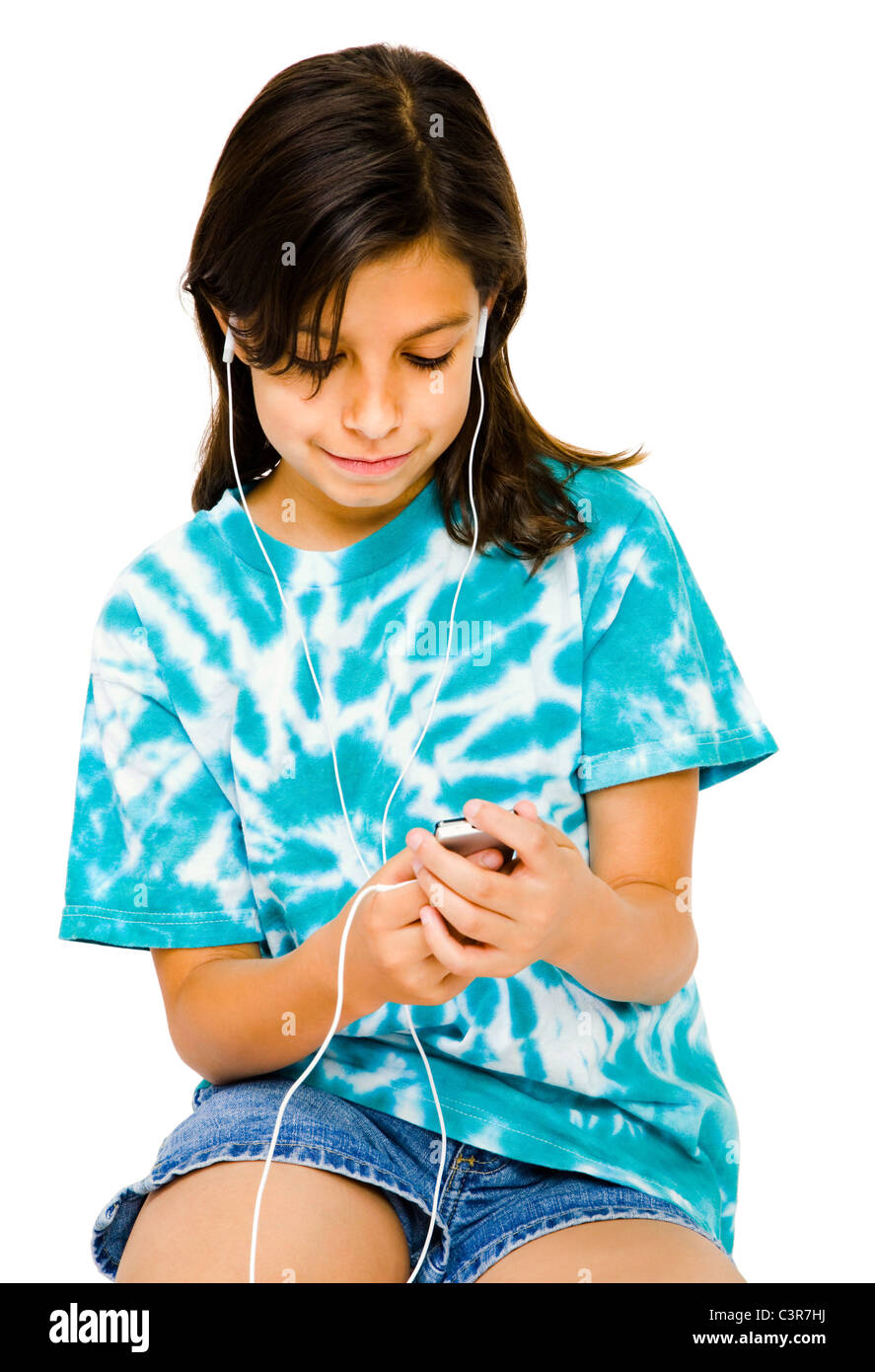 Child listening to music on a MP3 player and smiling isolated over ...