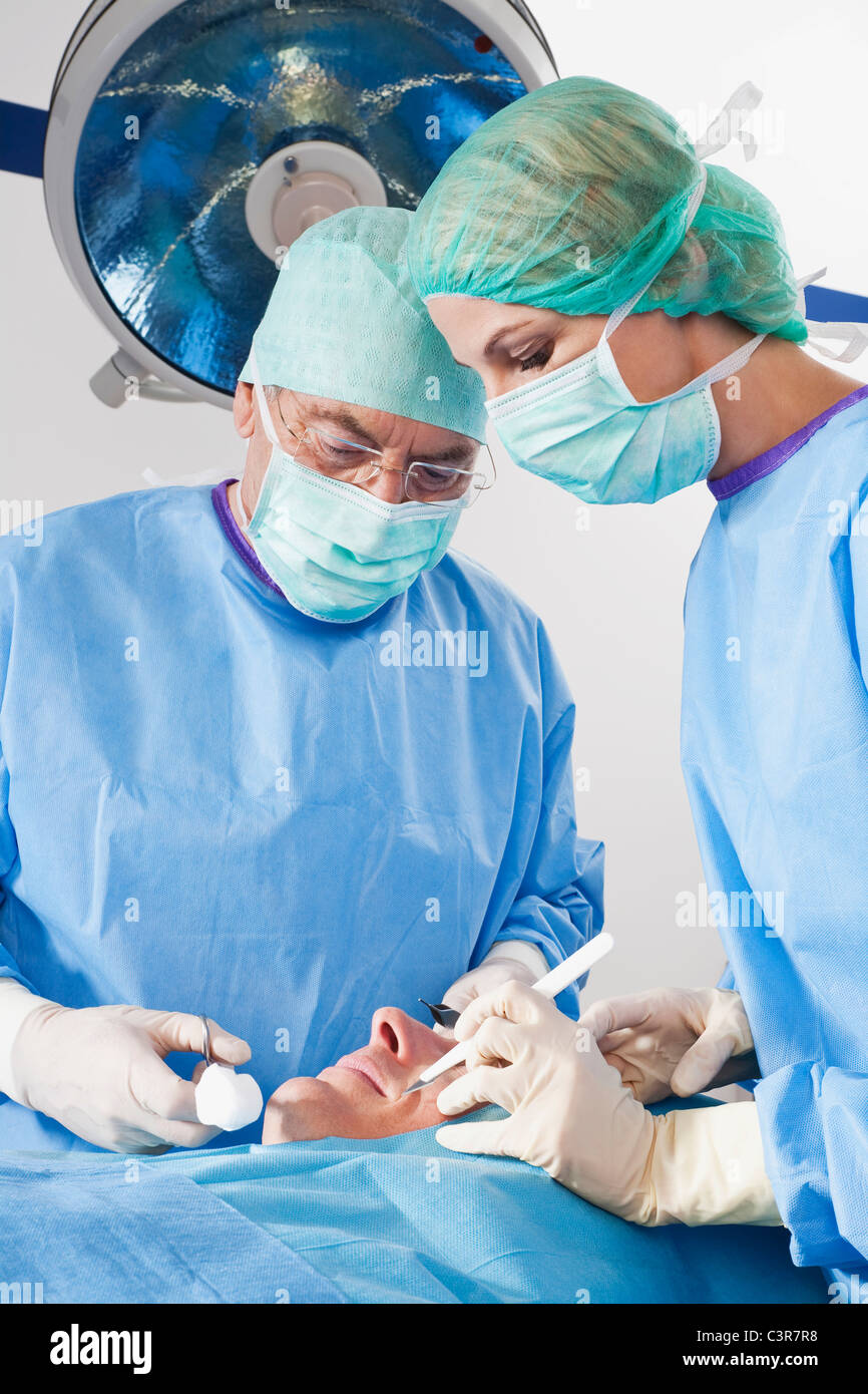 Germany, Munich, Surgeons performing operation Stock Photo - Alamy