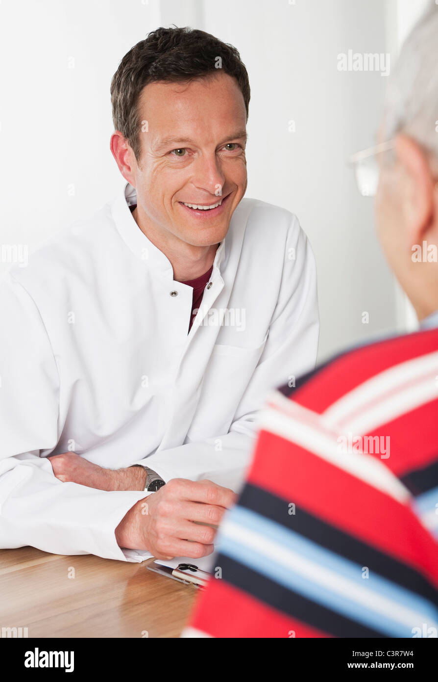 Germany, Munich, Doctor talking to patient Stock Photo - Alamy