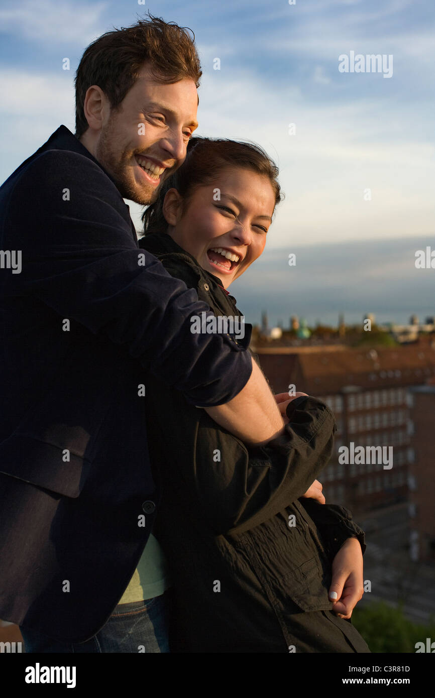 Young man cuddling on his girlfriend Stock Photo - Alamy