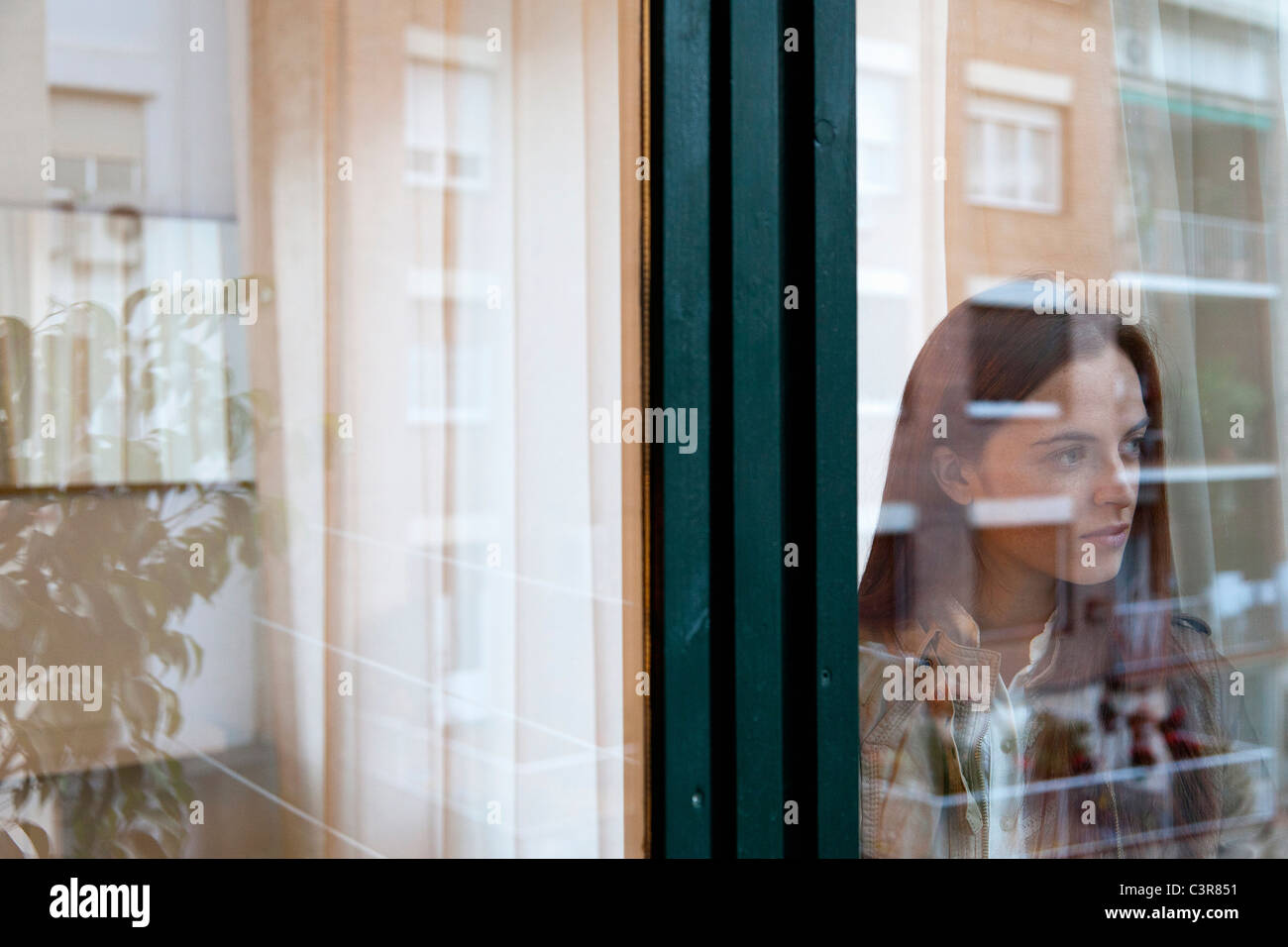 Woman by the window Stock Photo - Alamy