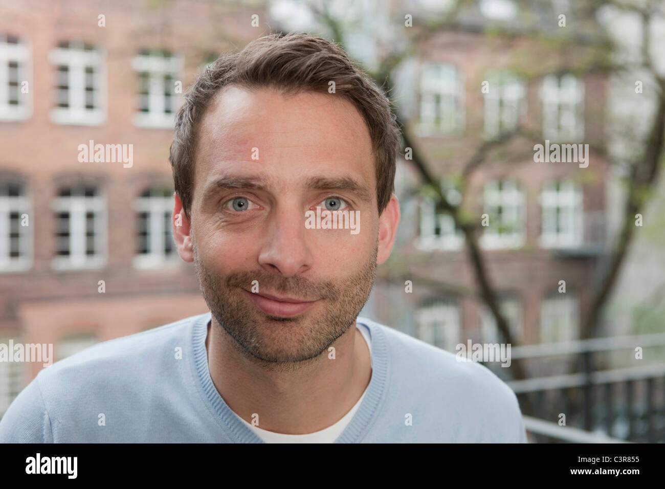 Germany, Portrait of man in balcony, smiling Stock Photo - Alamy