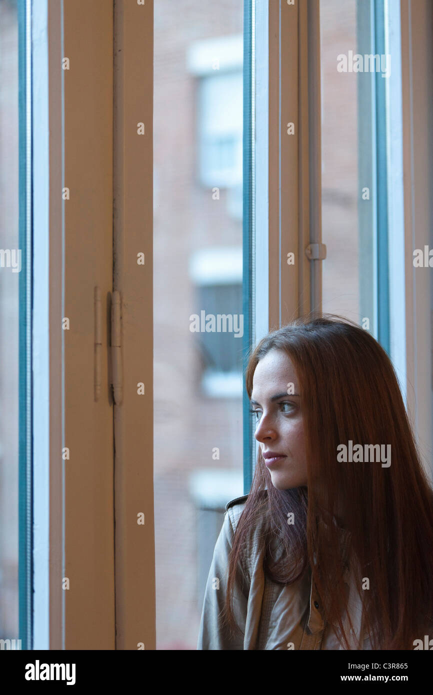 Woman by the window Stock Photo - Alamy