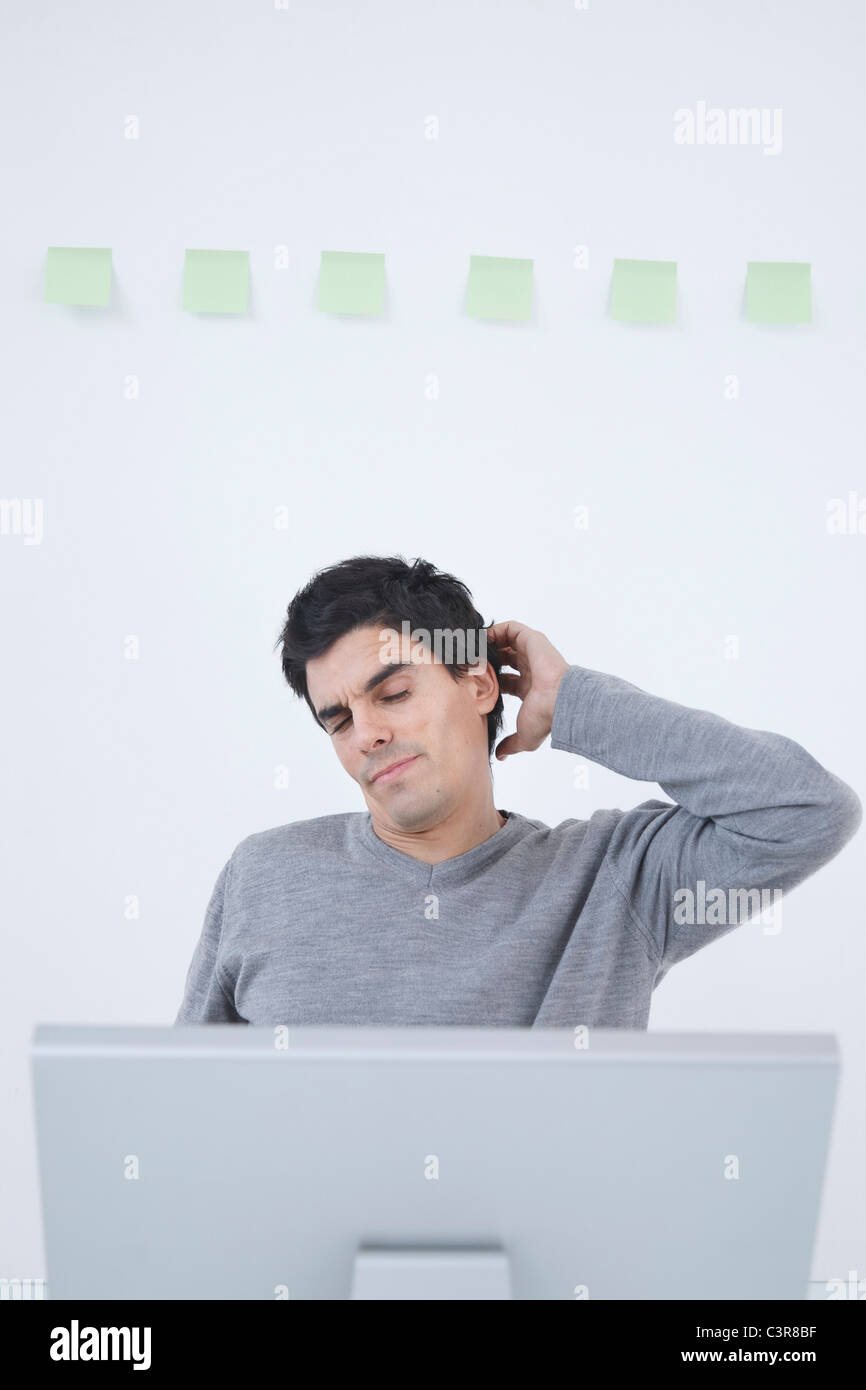 Man stretching at computer Stock Photo - Alamy