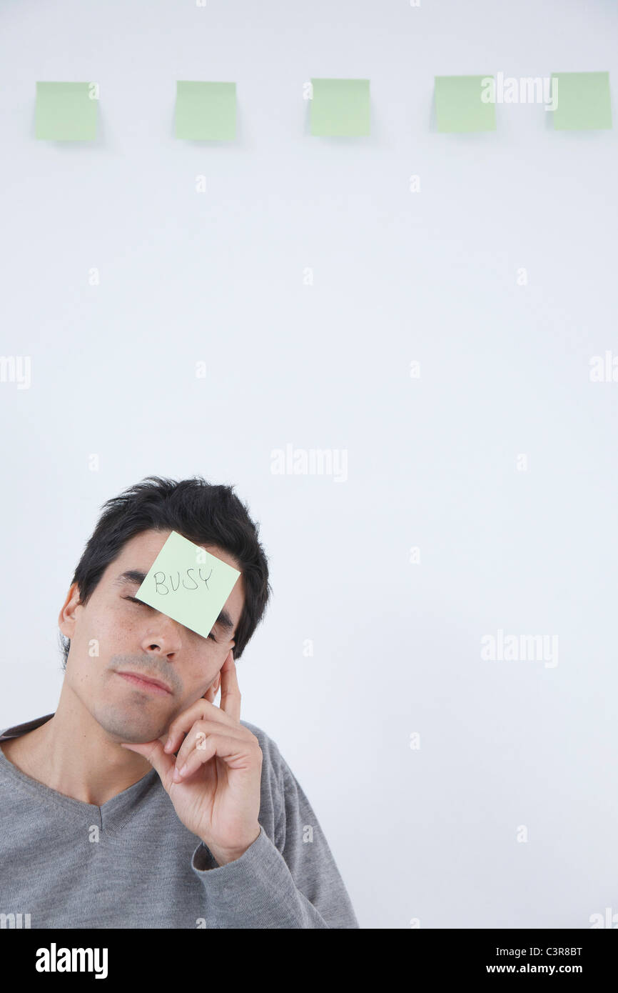 Man with 'busy' post-it note on his head Stock Photo - Alamy