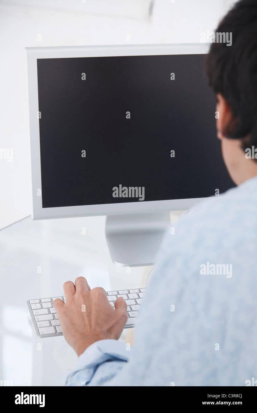 Blank computer screen , shot from over a mans shoulder Stock Photo - Alamy