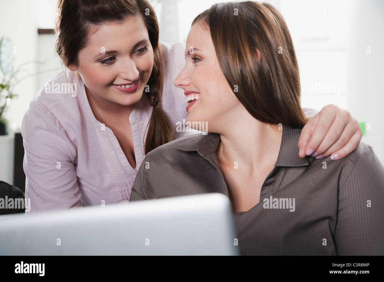 Germany, Cologne, Young women using laptop Stock Photo - Alamy