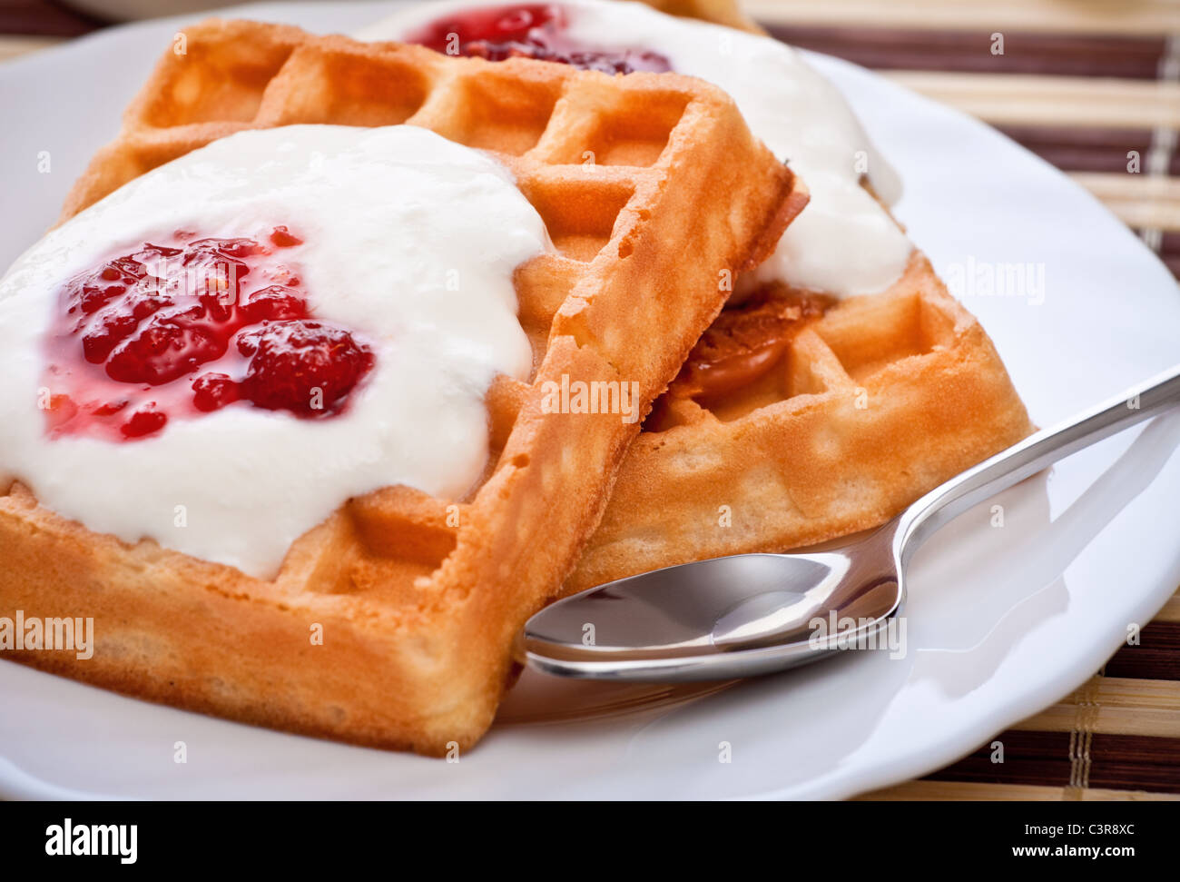 dessert with soft waffle and raspberry jam Stock Photo - Alamy
