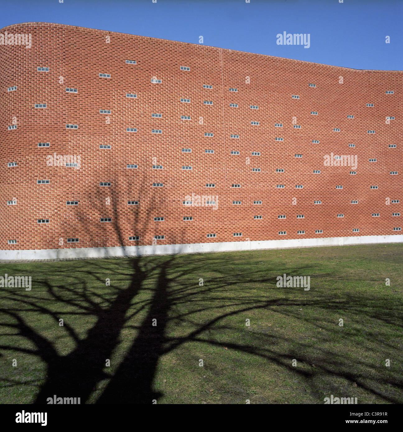 Estonia, View of modern red building with tree shadow Stock Photo - Alamy