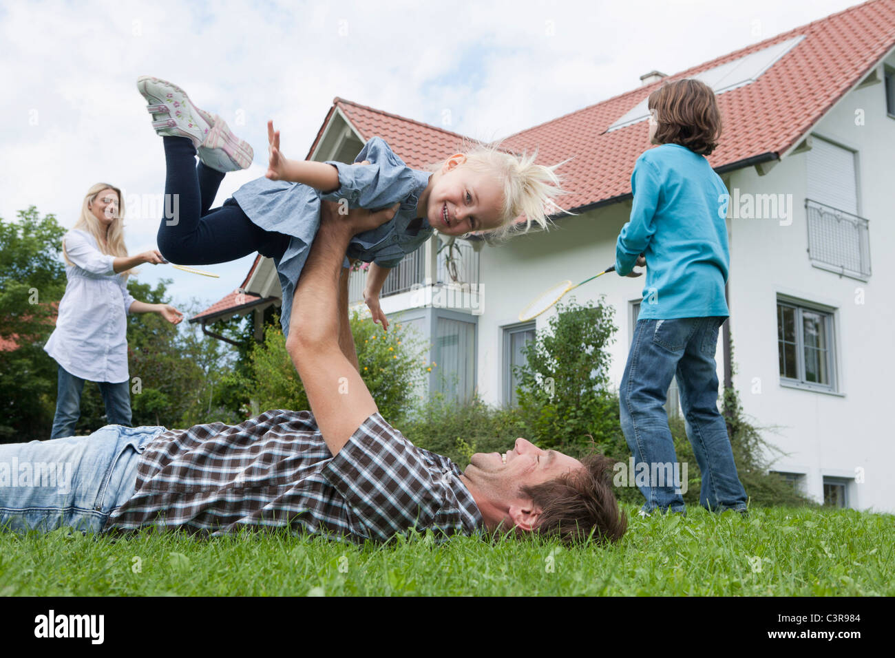 Germany, Munich, Family having fun in garden, smiling Stock Photo - Alamy
