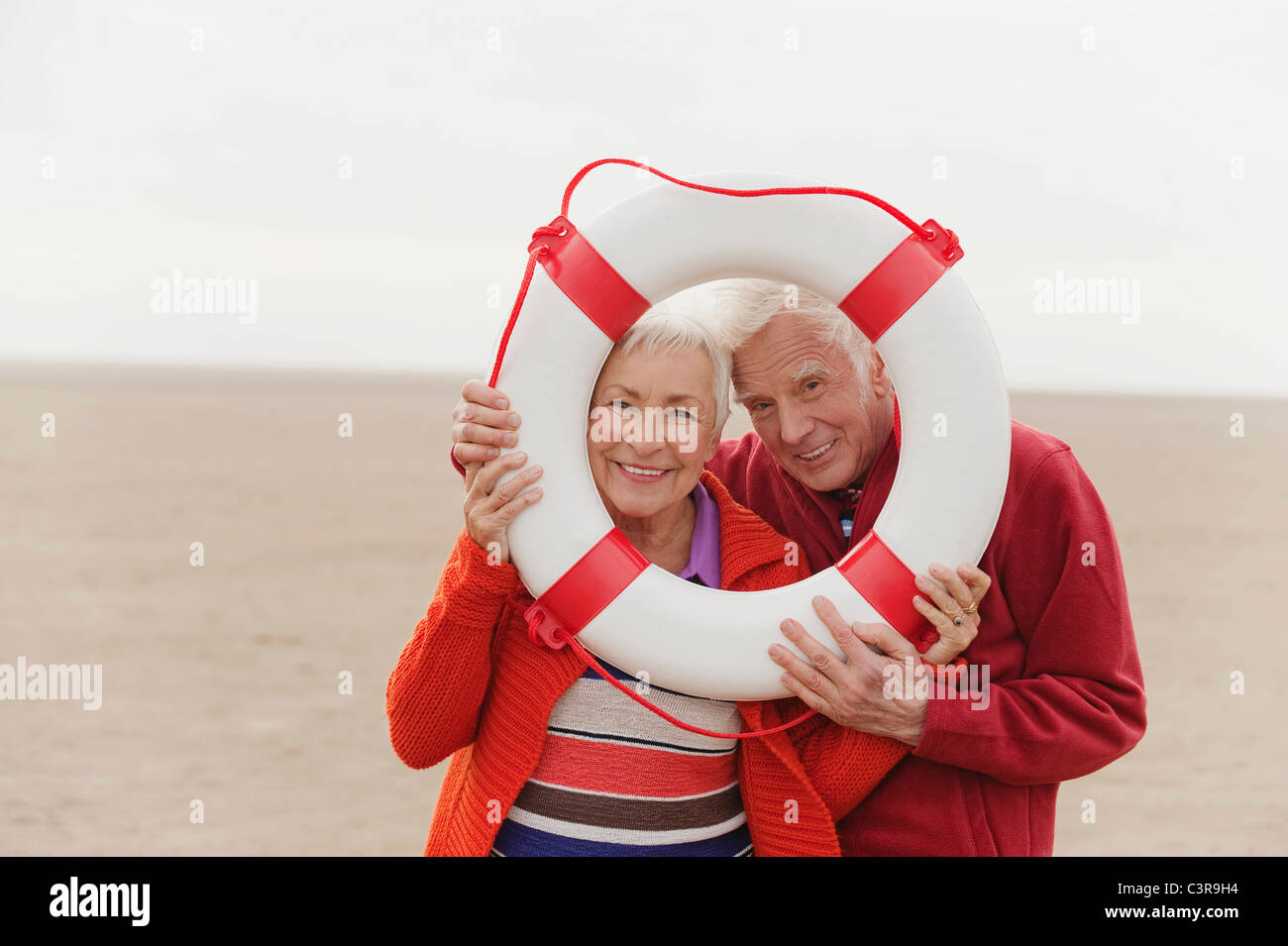 Germany, St Peter-Ording, North Sea, Senior couple looking through ...