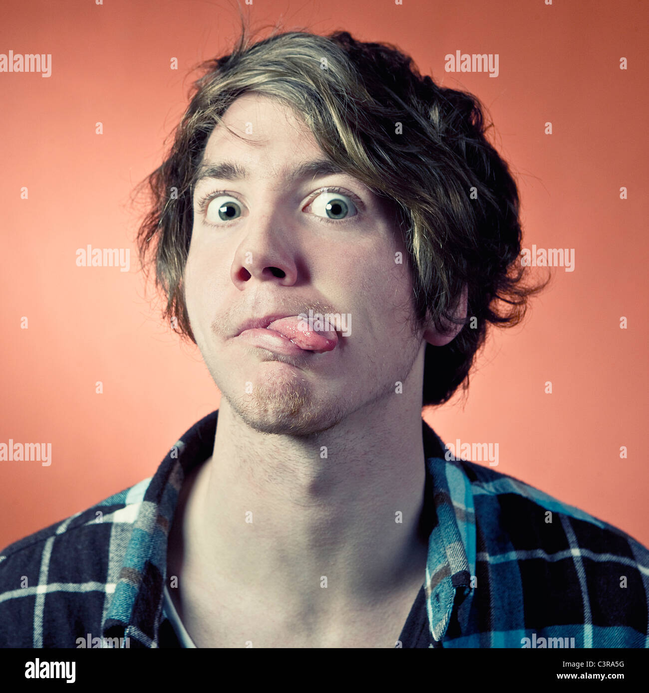 Man making sticking out tongue, portrait Stock Photo - Alamy
