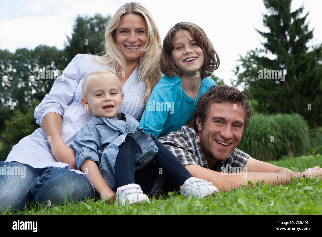 Germany, Munich, Family in garden, smiling, portrait Stock Photo - Alamy
