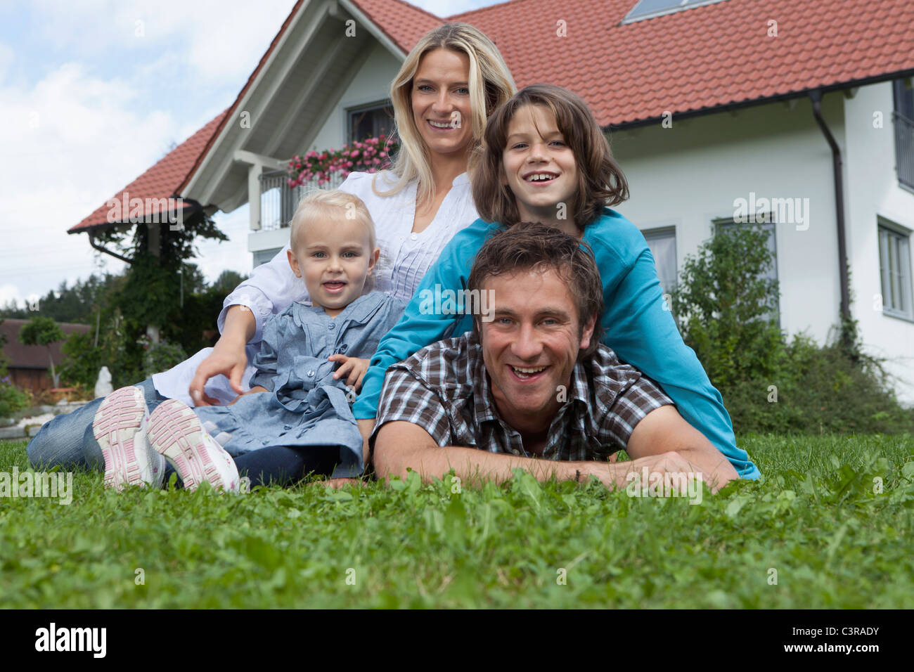 Germany, Munich, Family in front of house, smiling, portrait Stock ...