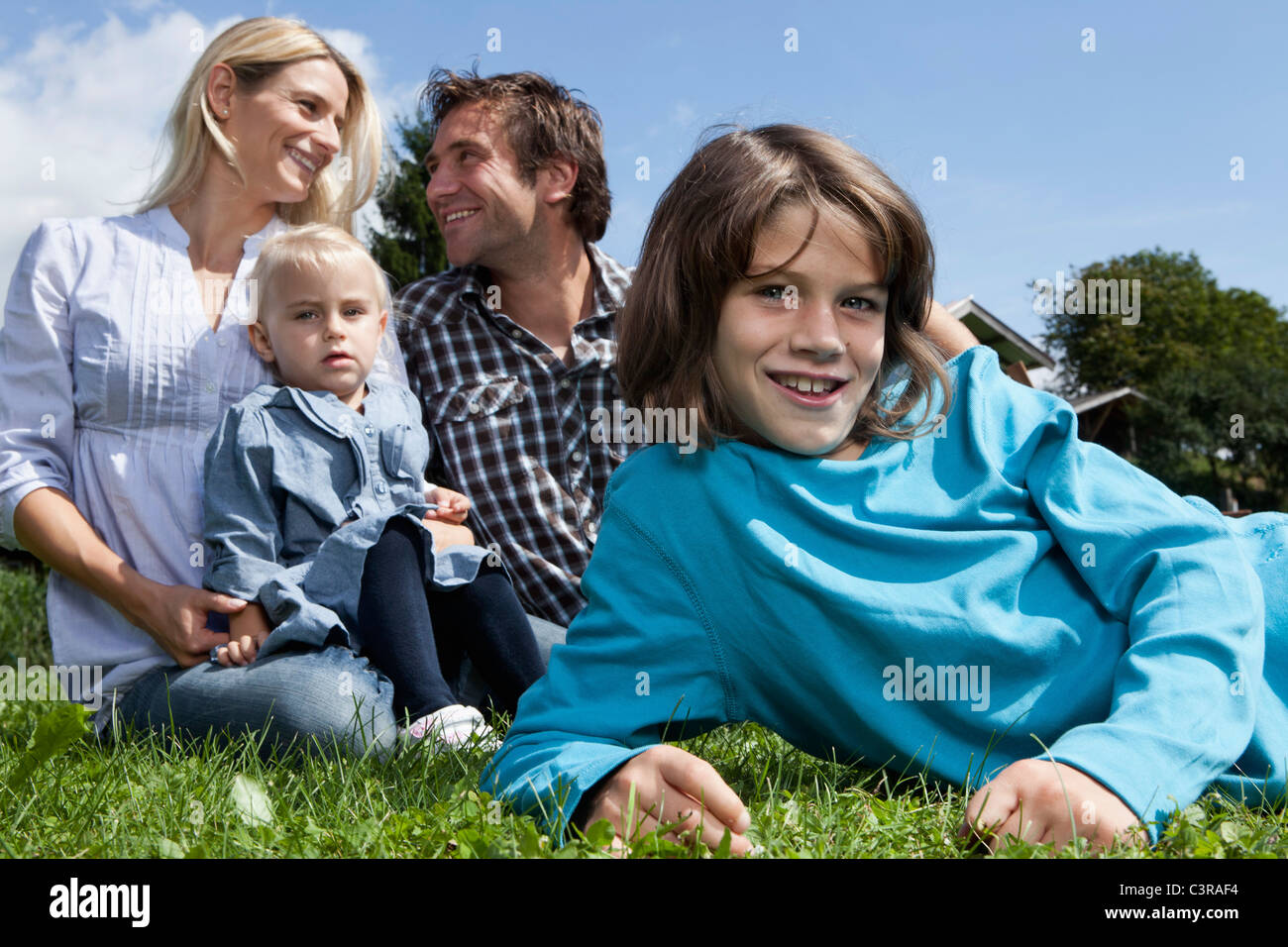 Germany, Munich, Family in garden, smiling Stock Photo - Alamy