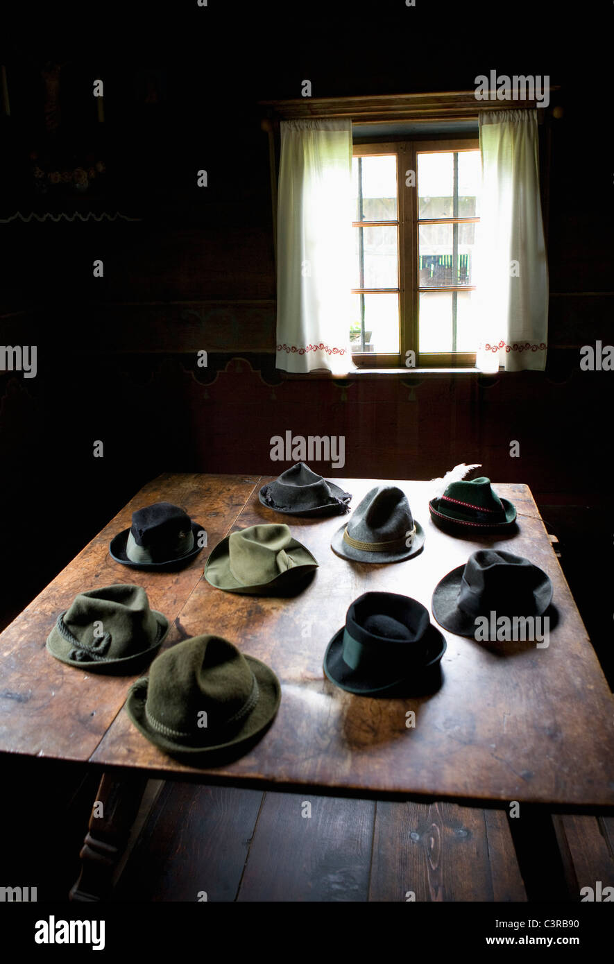 Austria, Styria, Stuebing, Variety of hats on table in farmhouse Stock ...