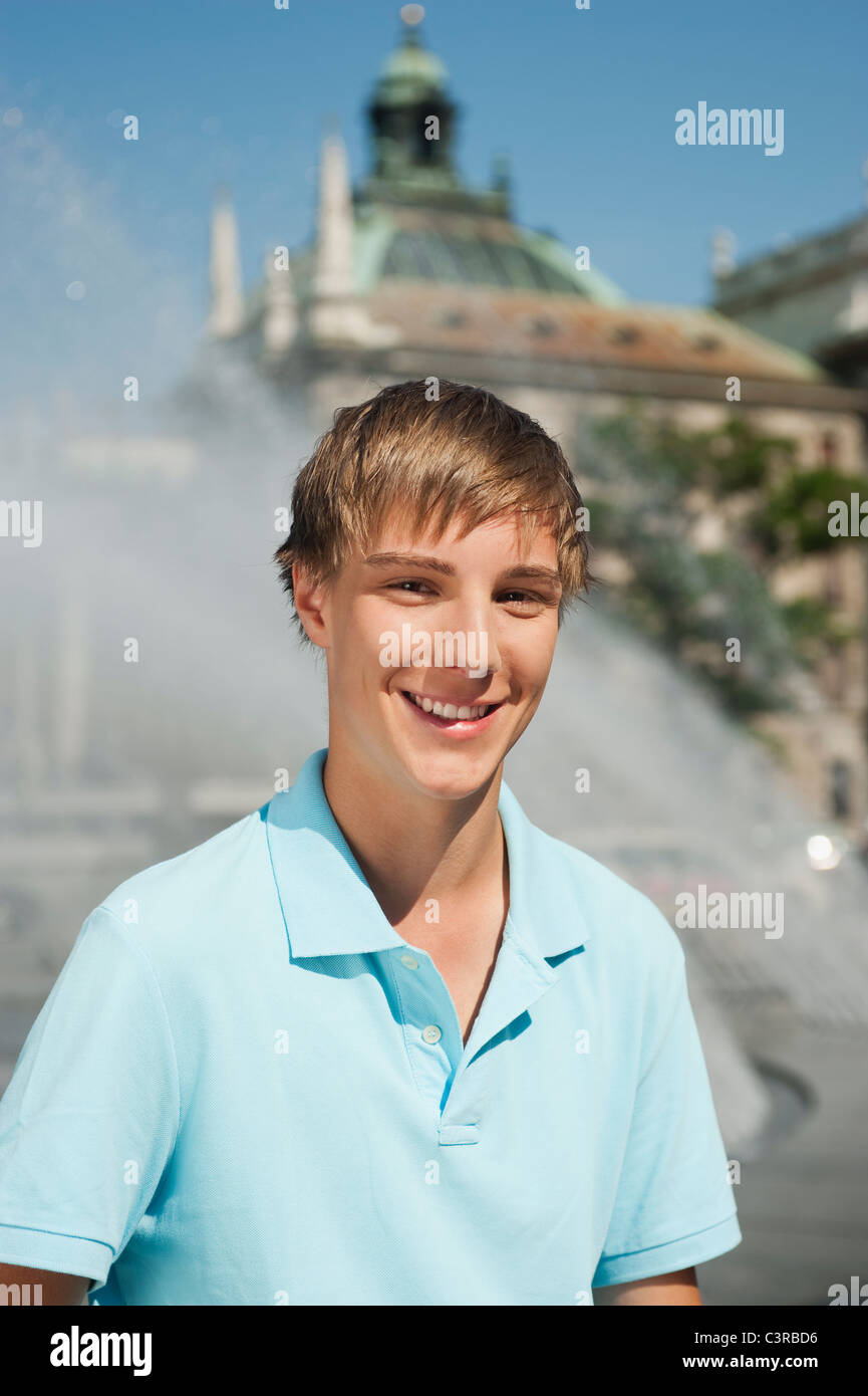 Germany, Munich, Karlsplatz, Young man smiling, portrait Stock Photo ...