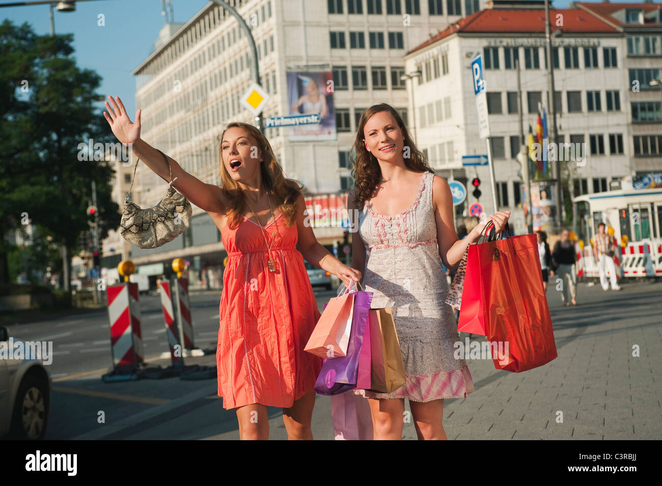Germany, Munich, Karlsplatz, Young women with shopping bags Stock Photo ...