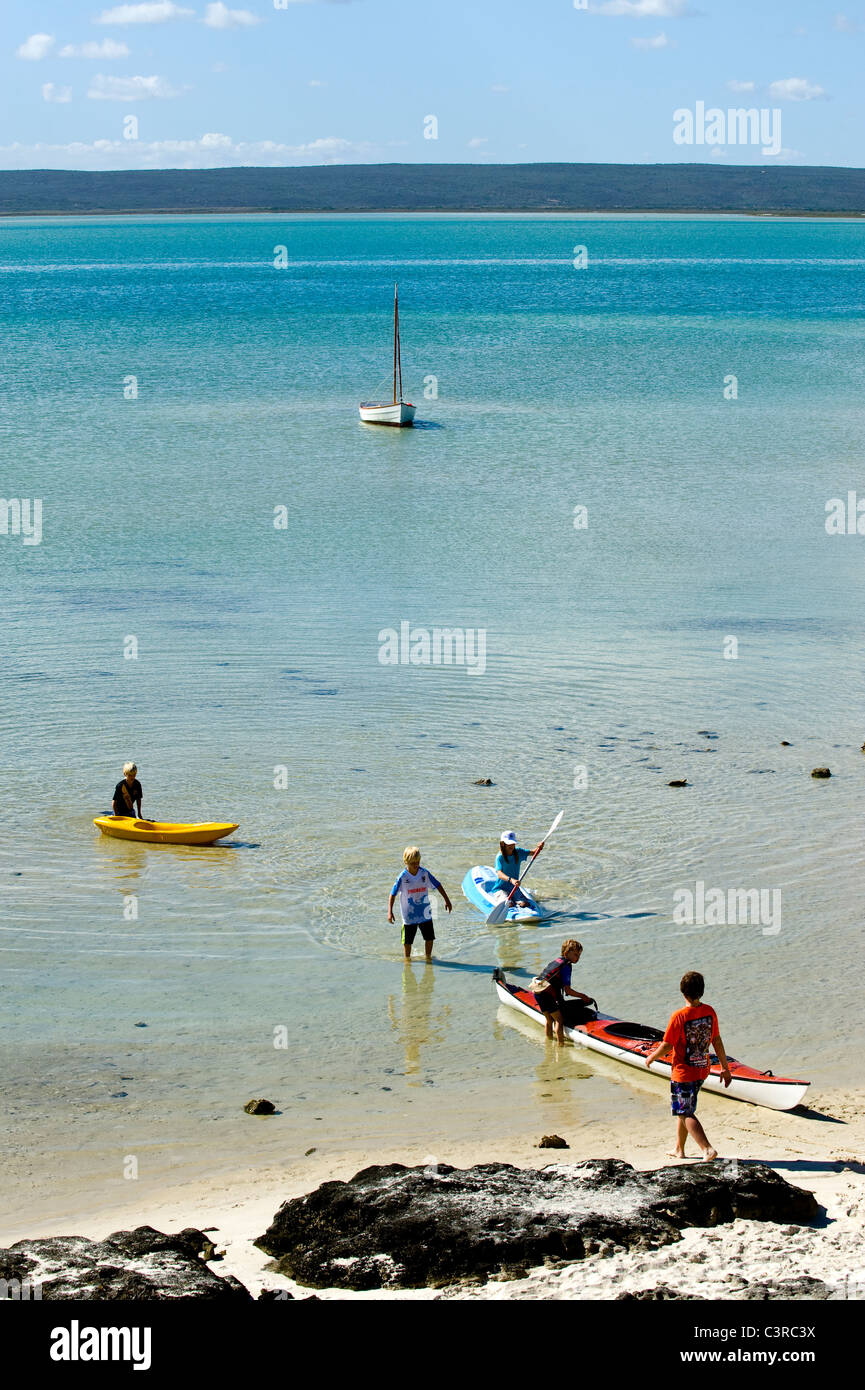 Children with canoes in the Langebaan lagoon, Churchhaven in West Coast ...