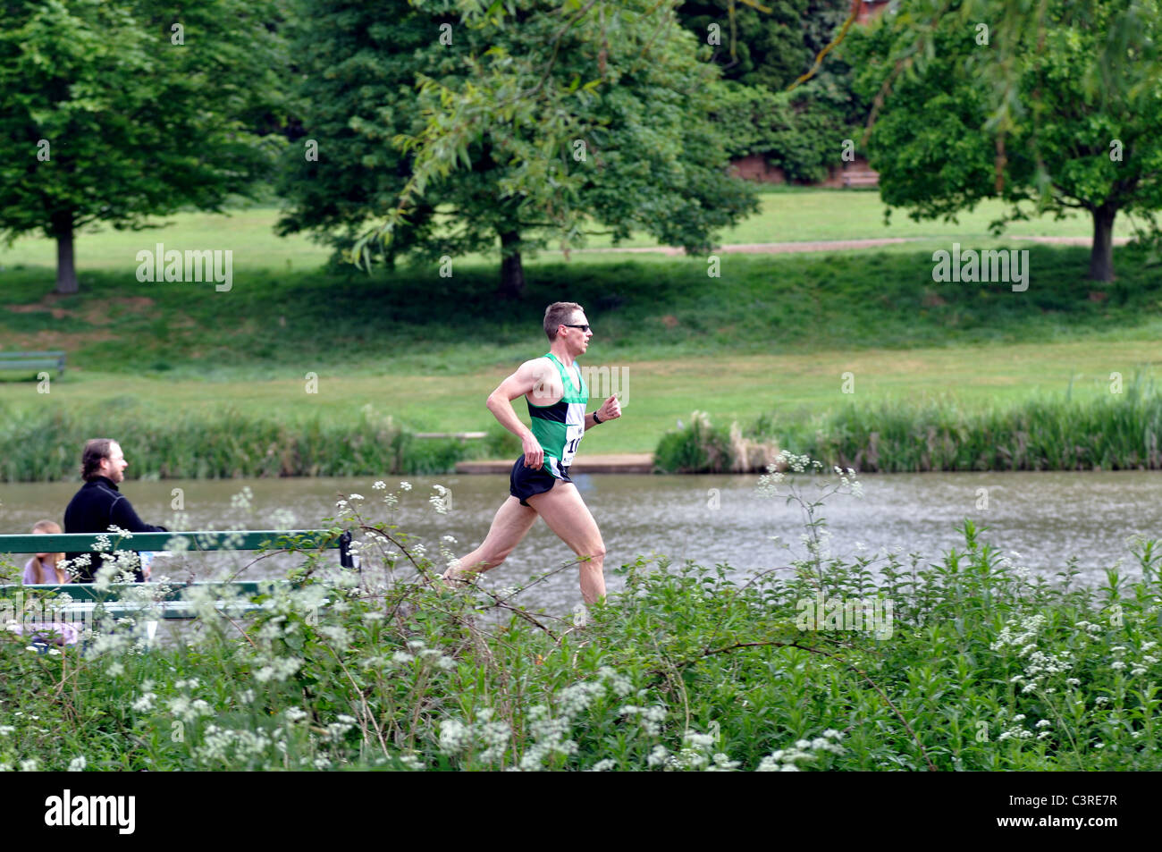 Side view of man running in a race Stock Photo - Alamy