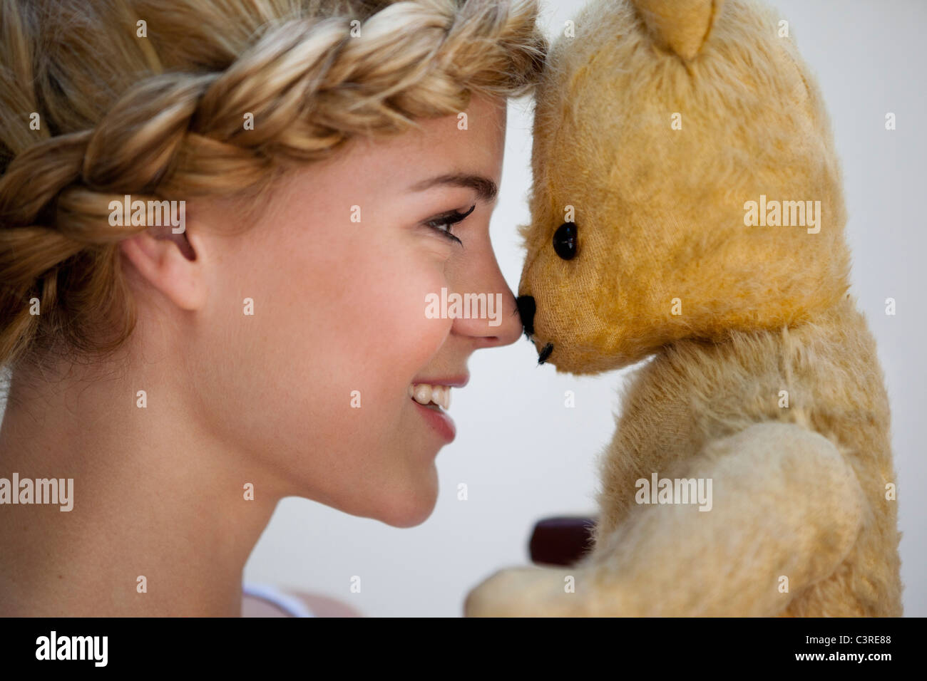 Girl smiling at teddy Stock Photo - Alamy