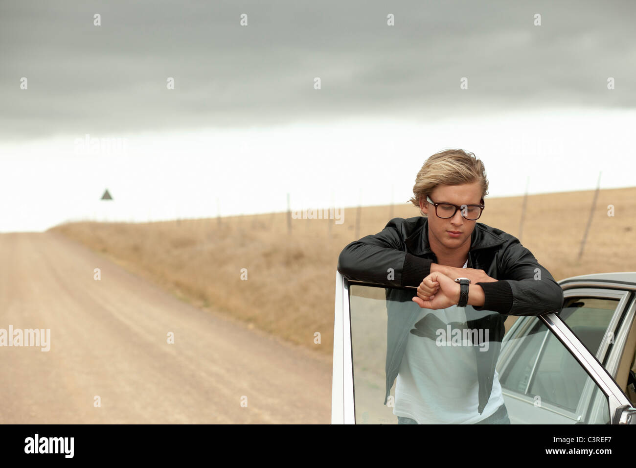 Boy looking on watch Stock Photo - Alamy