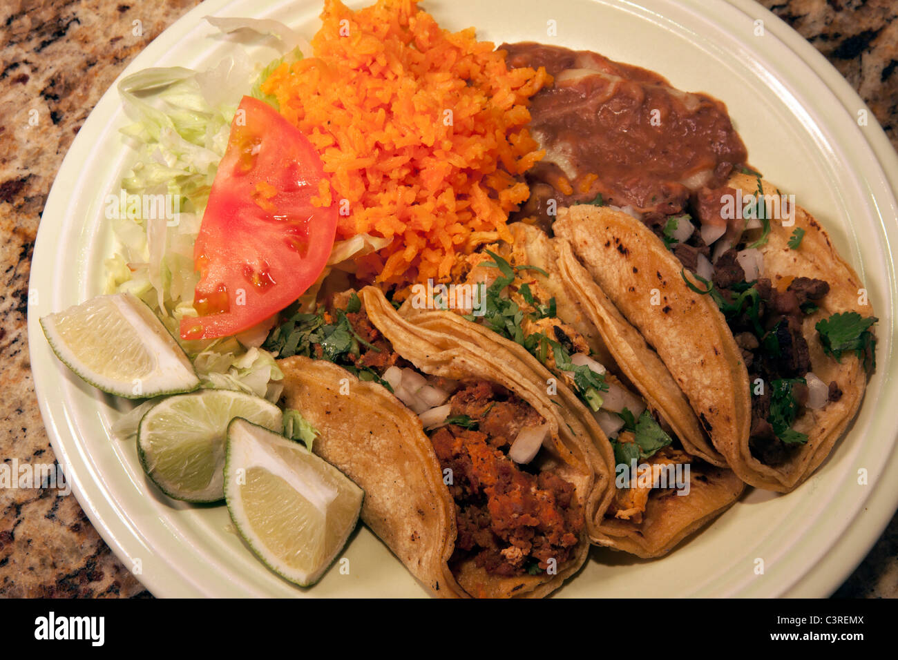 Plate of three tacos with rice and beans USA Stock Photo - Alamy