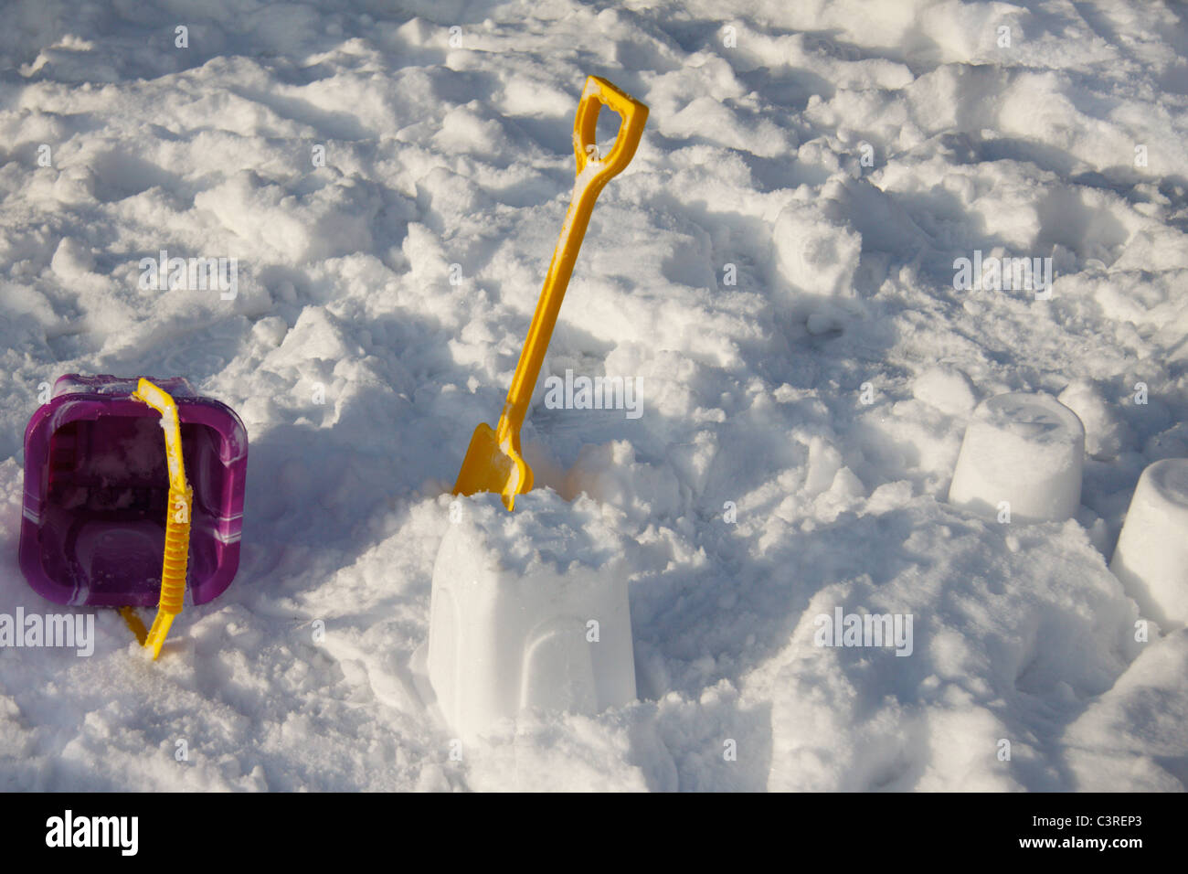 Having fun with buckets and spades in snow Stock Photo - Alamy